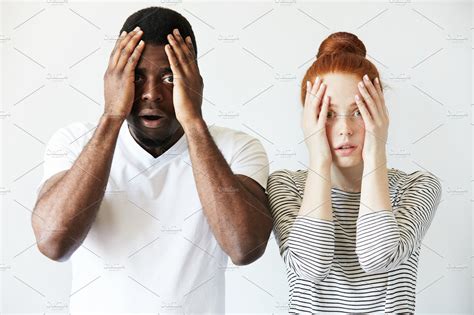 Portrait Of Shocked Interracial Couple African Man And Redhead