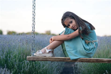Premium Photo Sad Girl In A Lavender Field On A Swing