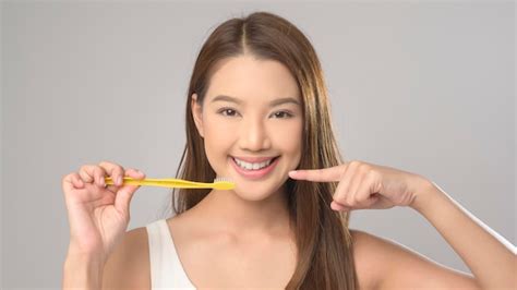 Premium Photo Young Smiling Woman Holding Toothbrush Over White