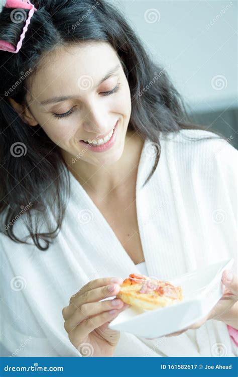 A Beautiful Woman Wearing A Towel And A White Bathrobe Has To Eat A