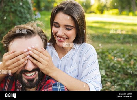 Image Of Beautiful Woman Dressed In Casual Wear Covering Mans Eyes