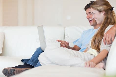 Happy Couple Online Shopping Having Fun On Laptop On Sofa Stock Image