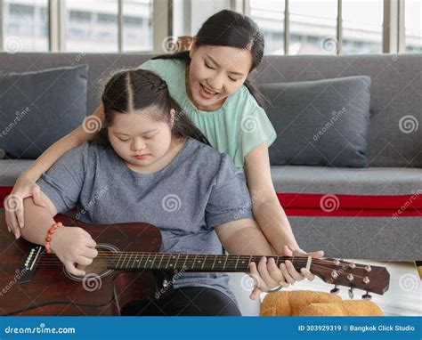 Asian Lovely Mother Helping Young Chubby Down Syndrome Autistic Autism