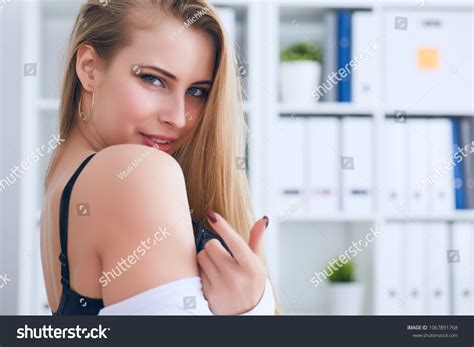 Стоковая фотография 1067891768 Sexy Undressed Secretary Beckons Finger