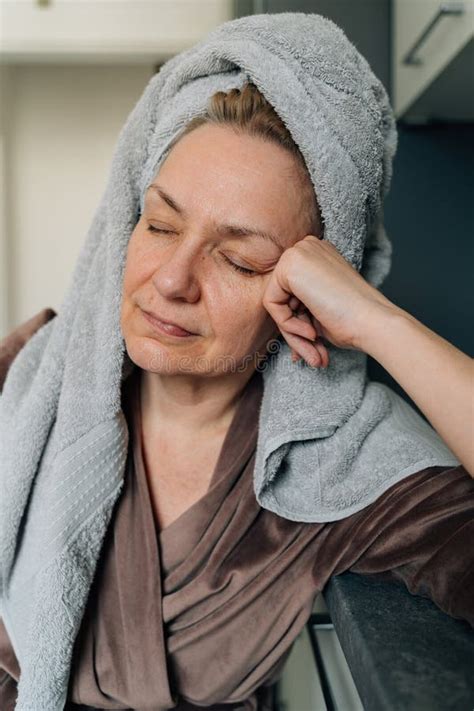 Mature Middle Age Woman At Home With Bathrobe And Towel On Wet Hair