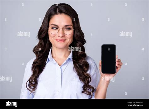 Photo Of Interested Lady Hold Telephone Look Side Empty Space Screen