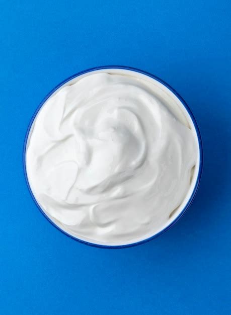 Premium Photo Bowl Of Sour Cream On Blue Background