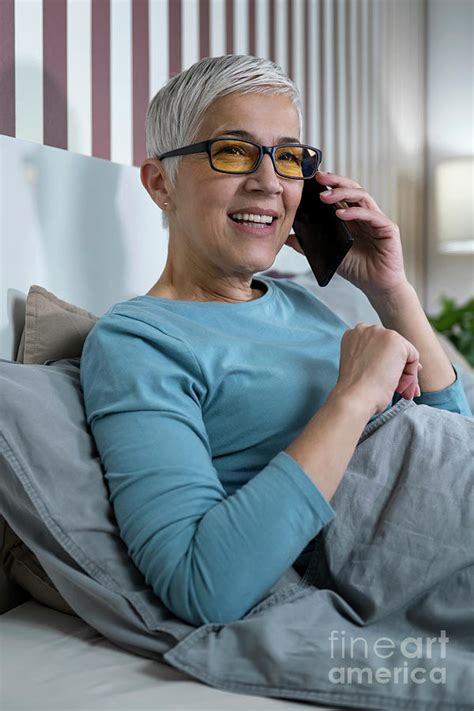 Mature Woman Wearing Blue Light Blocking Glasses Photograph By Microgen