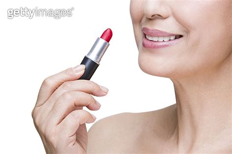 Beautiful Mature Woman Applying Lipstick 이미지 A10788411 게티이미지뱅크