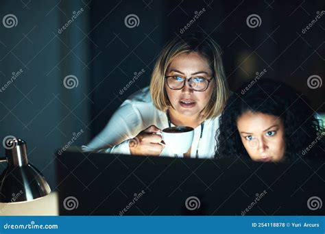 Teamwork Will Take Them Through The Night Two Colleagues Using A