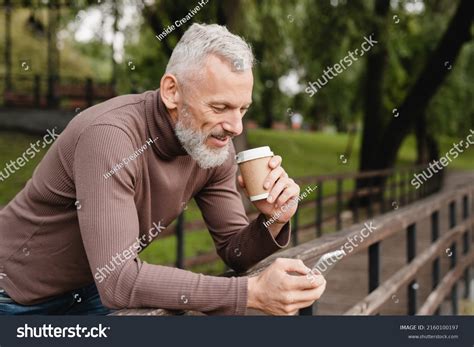 Стоковая фотография 2160100197 Handsome Mature Caucasian Man Using