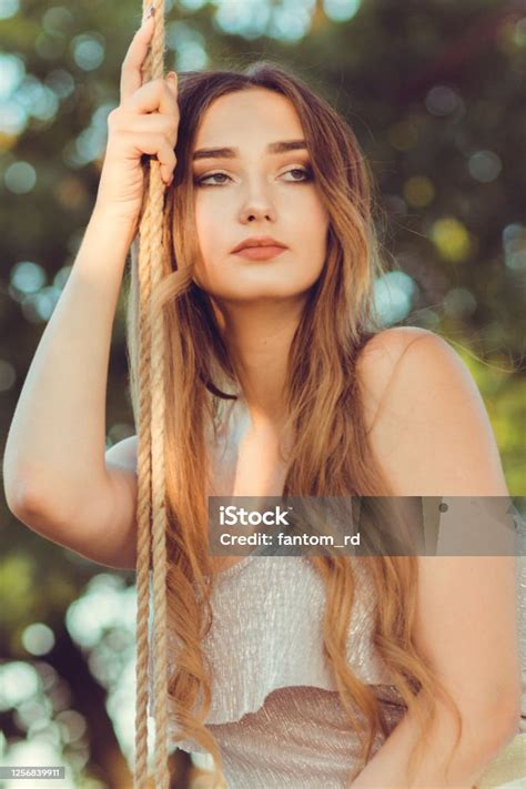 Portrait Of Beautiful Female Face Near Ropes Of Swing Girl Swinging On