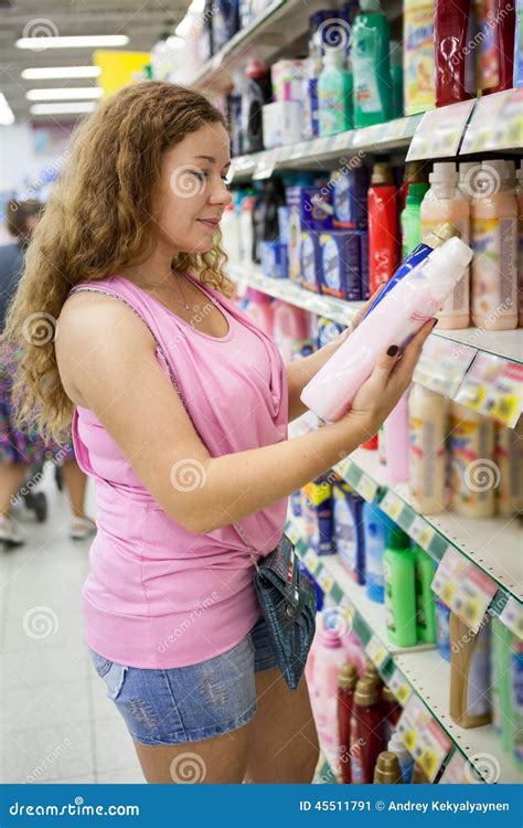 Young Woman Choosing Cleaning Detergent In Shop Stock Image Image Of