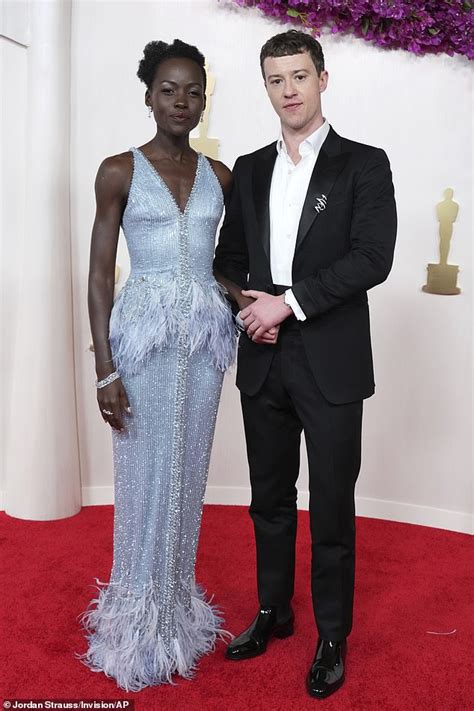 Lupita Nyongo Stuns In Glittering Feathered Gown At Oscars 2024 Poses