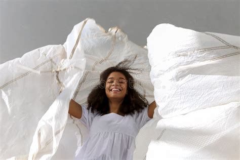 Overjoyed Happy African American Woman Jumping With White Fabric In Air