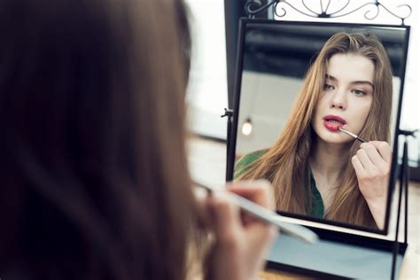 Free Photo Young Woman Rouging Lips