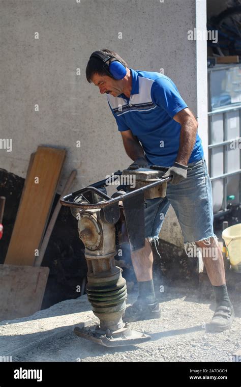 Image result for Indian Man Using Soil Compaction Machine