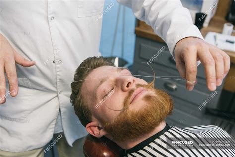 Traditional facial hair threading — client, sitting - Stock Photo ...