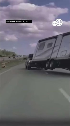Shocking video shows moment truck swerves causing trailer to overturn