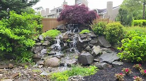 A public display waterfall at The Lakes of Honey Hollow in Hauppauge NY. A split of pondless waterfall designed and installed by Pond Paradise Designs and Rob Riccardo “The Waterfall Wizard” of Long Island NY #waterfalls #waterfeature #waterfeaturespecialist #fypシ #waterfall #pondlifestyle #pondlesswaterfall #cascade #streams #mossrock