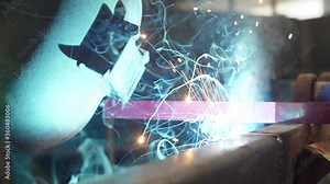 worker welding steel with mig welder machine slow motion