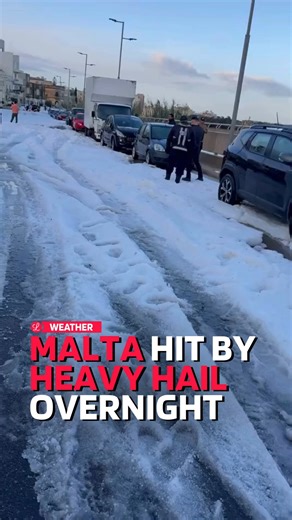 Malta woke up to ice covered roads after violent hailstorms hit overnight. Civil Protection Malta has warned the public to exercise extra caution on the roads following reports of heavy hail across the island. Western areas were hit hardest particularly Rabat and Baħrija where sudden hailstorms turned roads white and dangerously slippery. Photos and videos shared overnight show streets blanketed in hail with floodwater washing ice down empty roads. Malta Met Office has issued an orange weather w
