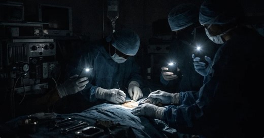Gynecological and obstetric doctors perform surgery in Havana lit by cell phones