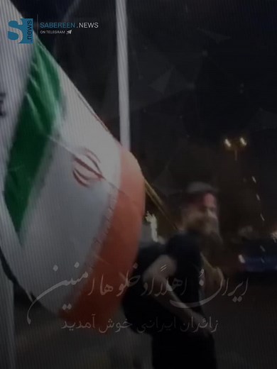 Nighttime Urban Event with Flags and Festive Atmosphere