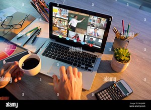 Hands of man using laptop for video call, with smiling diverse elementary school pupils on screen. communication technology and online education, digi Stock Photo - Alamy