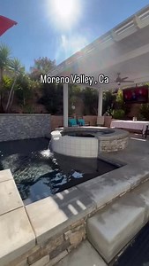 Discover the ultimate backyard oasis in Moreno Valley! This pool boasts a 42” raised bond beam, breathtaking sheer descent water features, and an 18-inch elevation. The exterior stone veneer adds a touch of luxury. Contact us for a free estimate!. | Bogner Pools