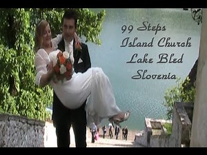 Groom carrying the Bride up 99 steps Island church Lake Bled Slovenia