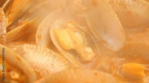 Frying clams with chili paste in pan , Thai street food.