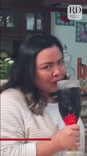 Woman transforms wine bottle into wine glass