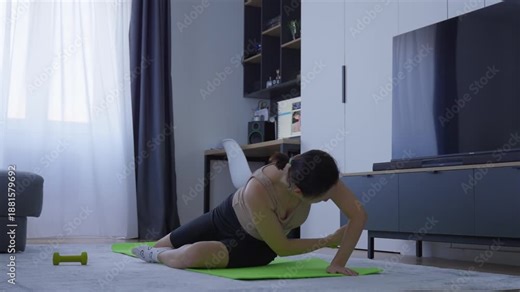 Woman doing seated torso rotation with dumbbell at home workout