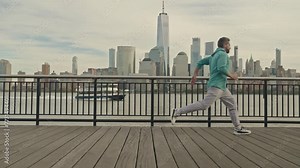 Run and Jump slow motion. man jogging in the NYC street park, man running on a sunny day, outdoor activity. Handsome man running in park during spring summer. Healthy active retirement sport outdoor.