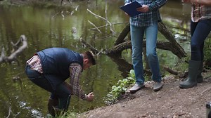 Collecting samples from polluted lake - Free Stock Video