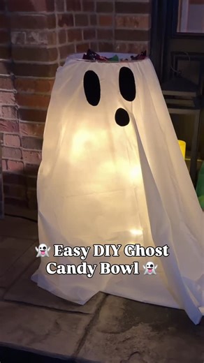 YWM Family on Instagram: "👻✨ Save + comment “BOO” for the supplies to make your own ghost candy bowl! 🎃🍬 This is such an easy Halloween DIY!! Just grab a stool, wrap it in lights, add a candy dish, and cover with a round plastic tablecloth — instant spooky perfection! 👻 Add a felt face + fill it with candy for the cutest trick-or-treat setup! 🍭 #DIYHalloween #SpookySeason #HalloweenDecor #HalloweenWeek #TrickOrTreatIdeas #GhostDIY #TrickOrTreat #LastMinuteHalloweenIdeas #SpookyCute #Hallowe