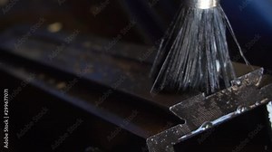 Cleaning desktop cnc mill post with mineral spirits and a brush in a wash basin in slow motion