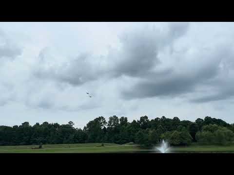 Two Helicopters Flying in Formation