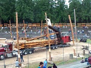 Vintage link belt cable log loader loading a kenworth logger