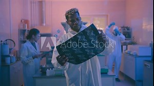 Young scientist checks results of DNA construction analysis on X-ray film