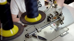 process of embroidering diamond pattern on cowhide in atelier on step sewing machine. Creating unique interior design from personal brand. designer sits and sews on fabric.
