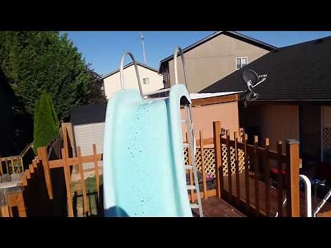 Intex above ground pool 18x9 with a deck, slide and sprayer.