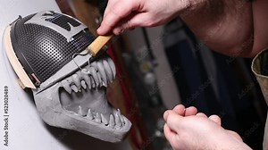 Artisan craftsman modeling mask based on plaster cast. Gypsum mold and plastic mask sculpting.