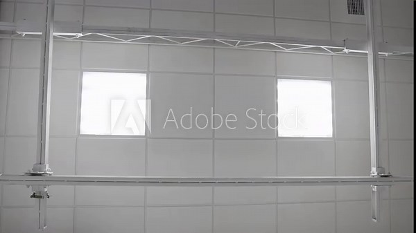 a man enters the office, turns on the light and sits down at his workplace. View from the chair. bottom up view of a man sitting down on camera.