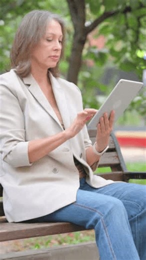 clip-3972304841-old-woman-loss-on-tablet-while-sitting