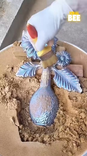 Pouring molten metal into a sand flower mold to create a detailed metal vase sculpture - satisfying sand casting art process | Viral Bee