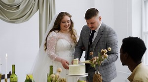 Bride and groom cutting the wedding cake | Free Stock Video Footage