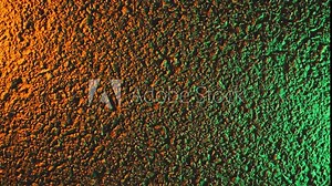 Asphalt texture in teal and orange highlights in motion. Asphalt Background in Motion. Colorful Texture in Urban. Driveway texture in the Dark at Night