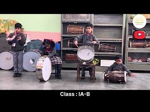 The first standard student played the rythem very beautifully on the patriotic song.